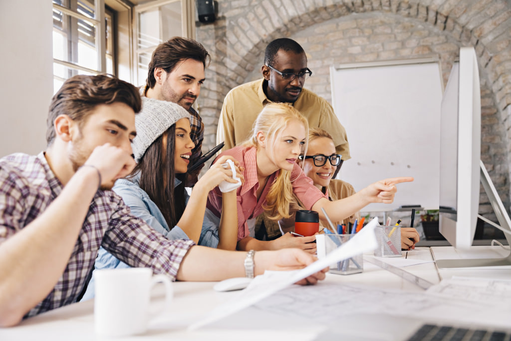 Photo of a group of coworkers working together - School of Business ...